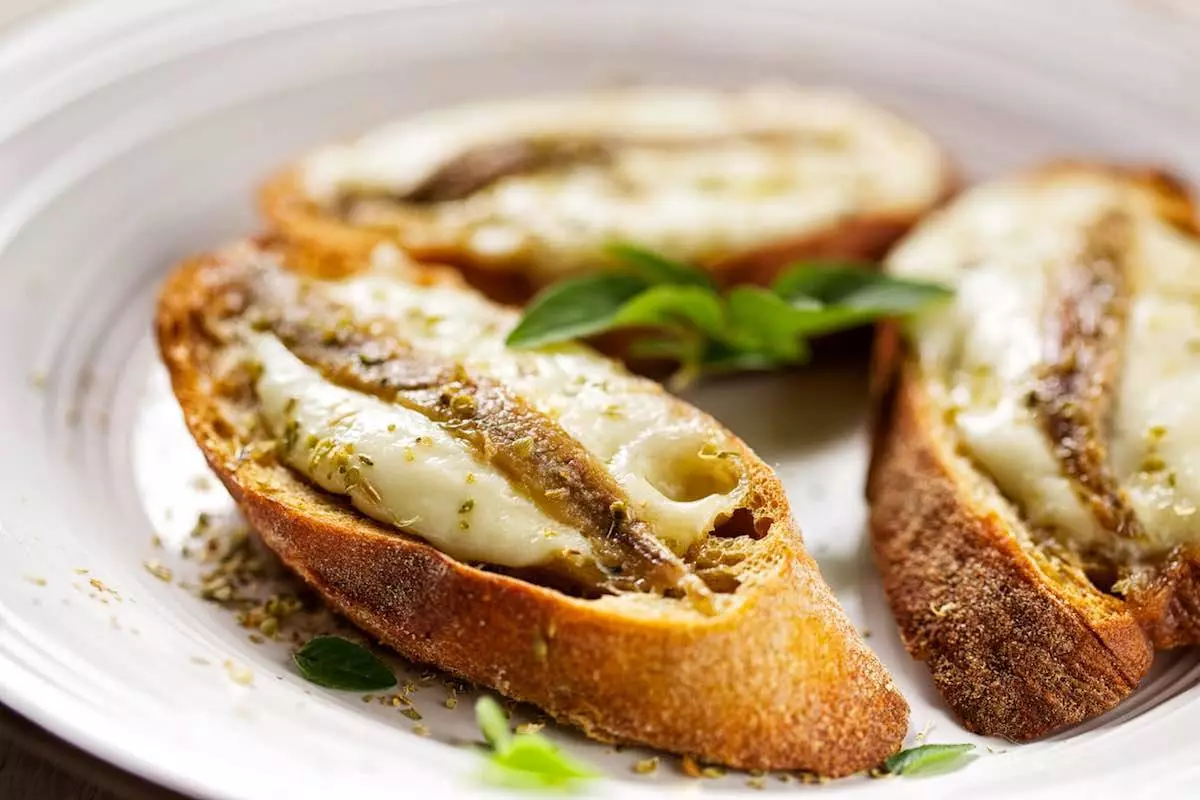 anchovies၊ ကျွဲ mozzarella နှင့် oregano တို့ပါရှိသော Crostini။ Ricettasprint.it မှ ချက်ပြုတ်နည်းများ