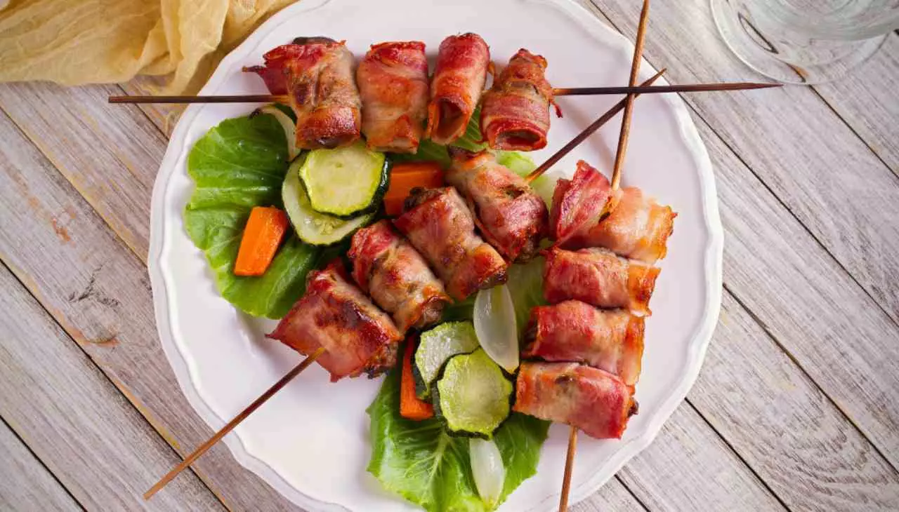 Meat finger food wrapped in bacon