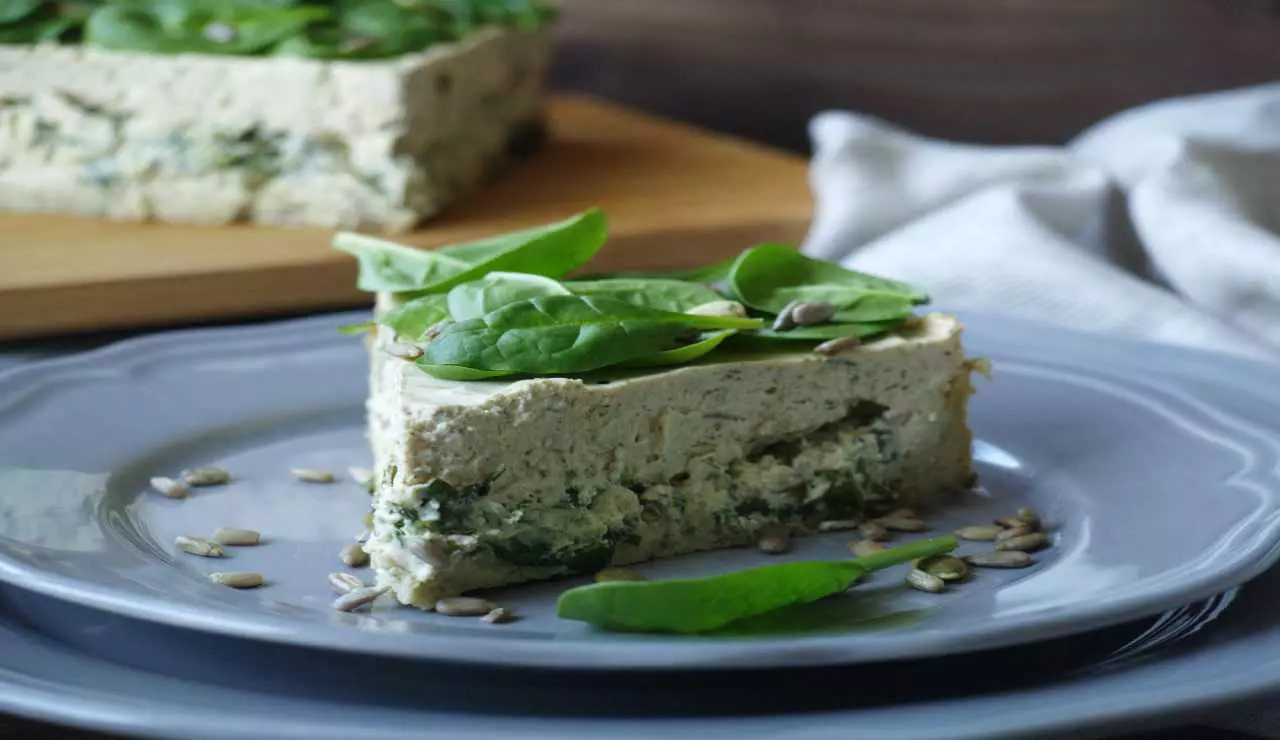 Salted ricotta cheesecake with spinach and pine nuts