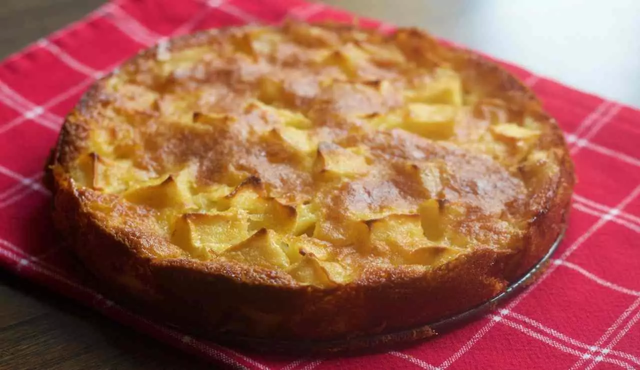 High and soft cake with apples and cinnamon in liqueur